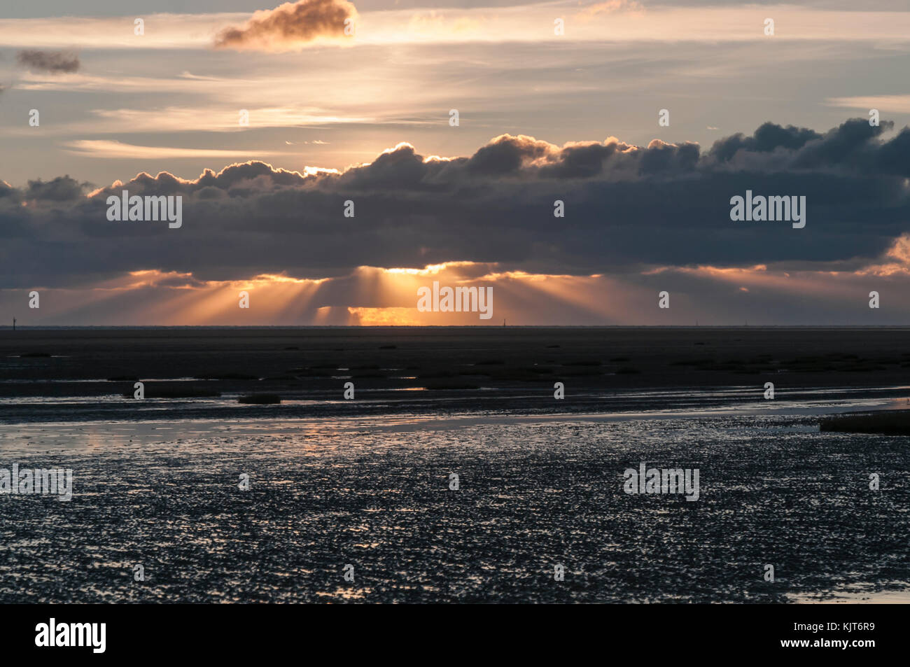 Sunset over the beach expanse and water pools towards the Irish Sea ...