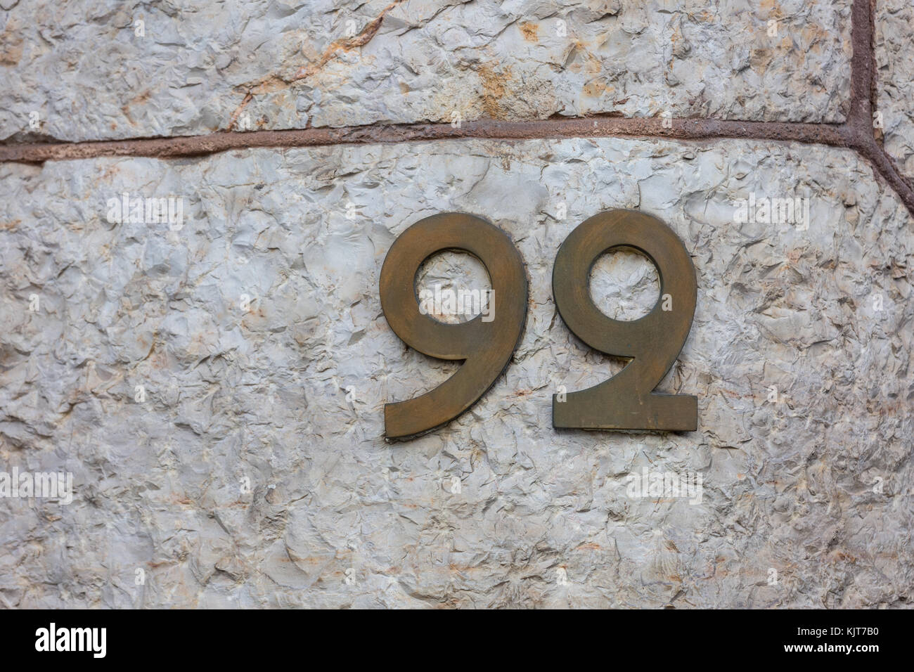 Copper number 99 (ninetynine) on a building in Barcelona, Spain Stock ...