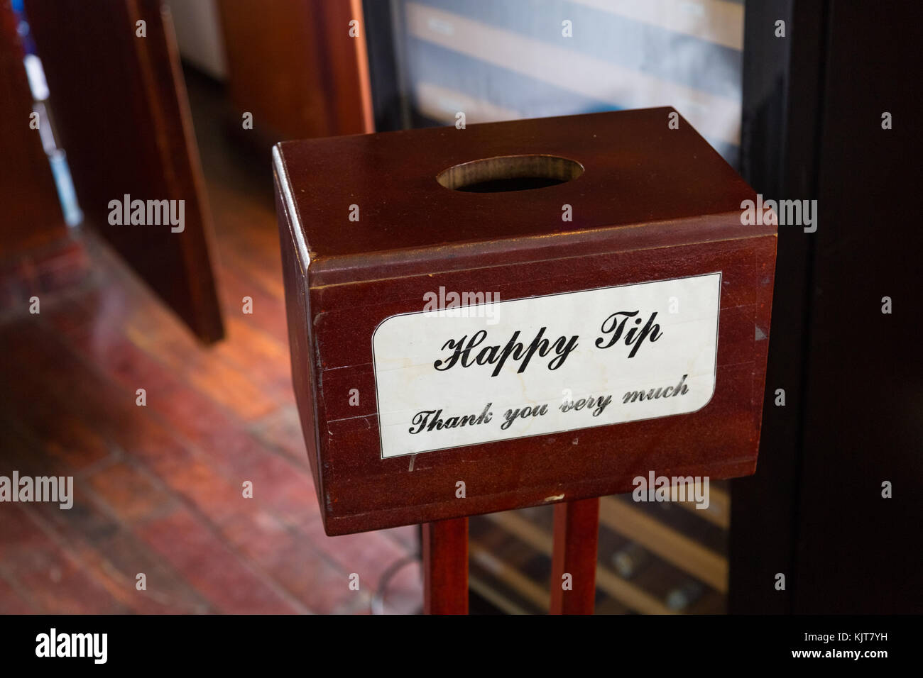 A small selfmade wooden tip box for the staff Stock Photo - Alamy