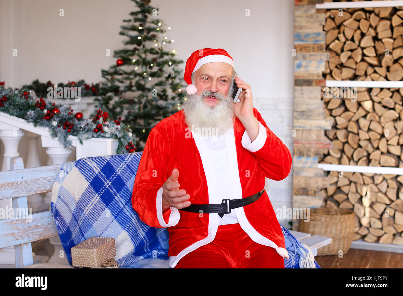 Hilarious Father Christmas calling parents by phone Stock Photo - Alamy