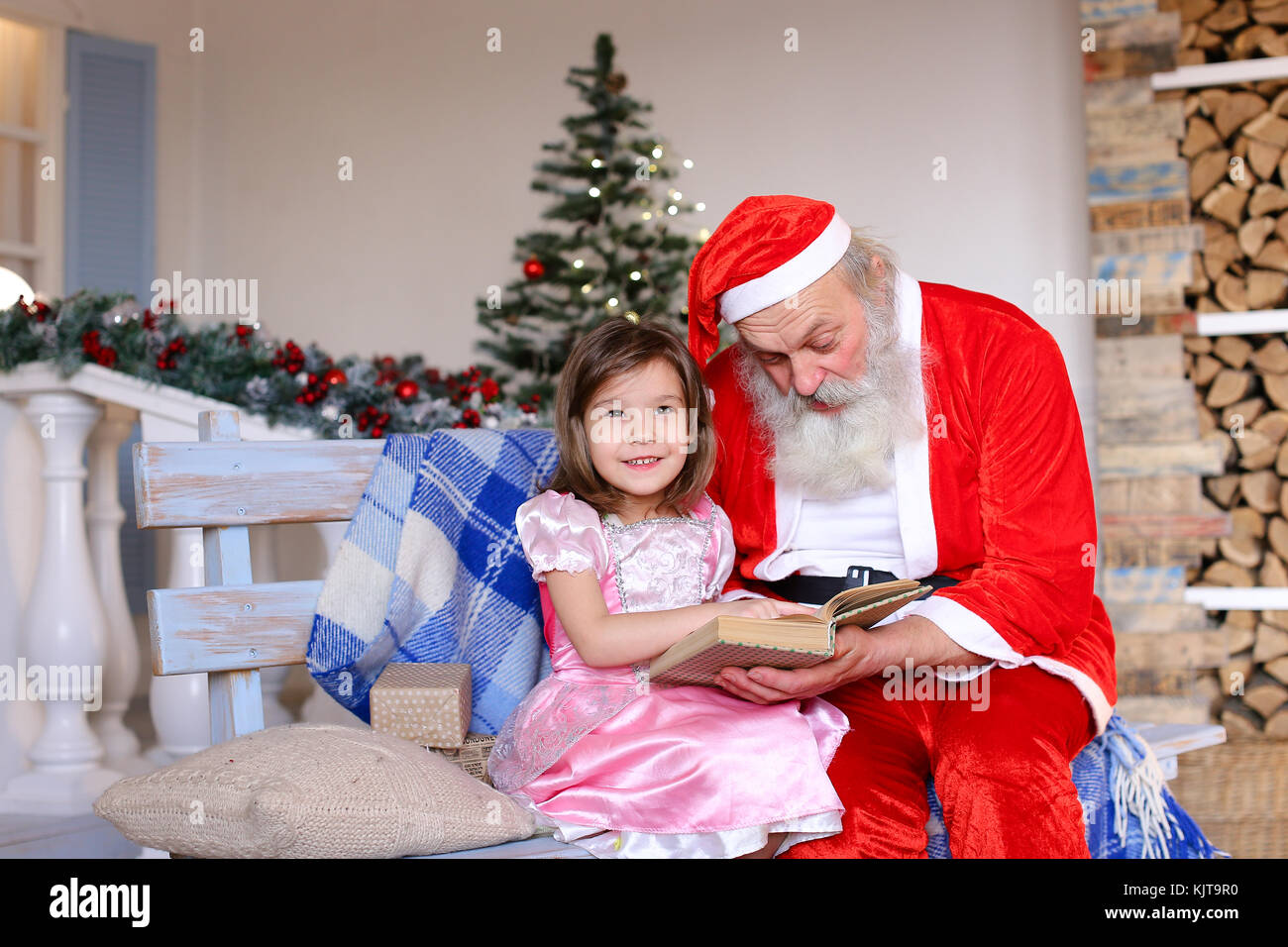 Beautiful child asking Father Christmas Stock Photo - Alamy