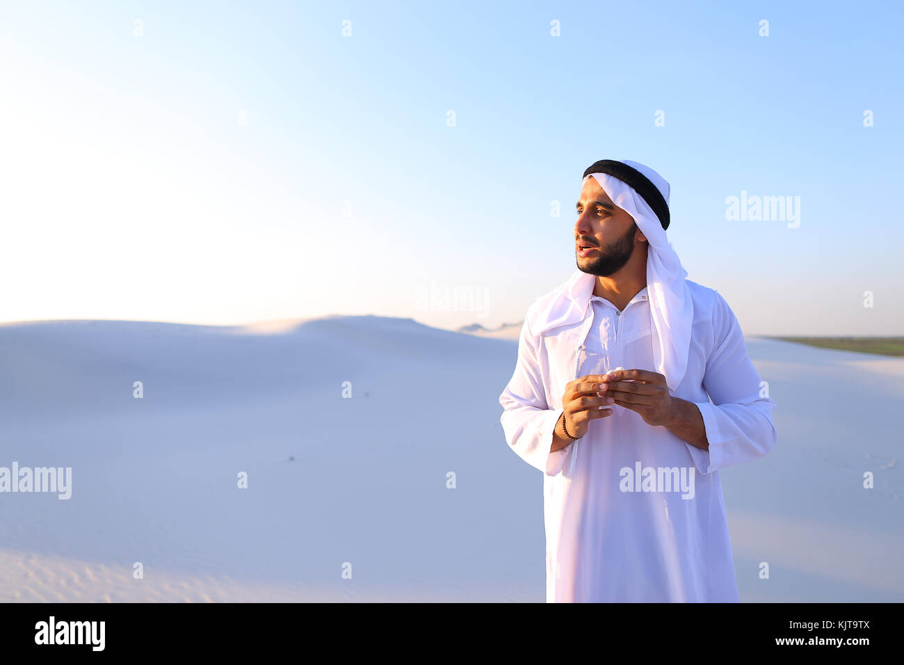 Arabian guy feels unpleasant sensations with cold, standing in m Stock ...