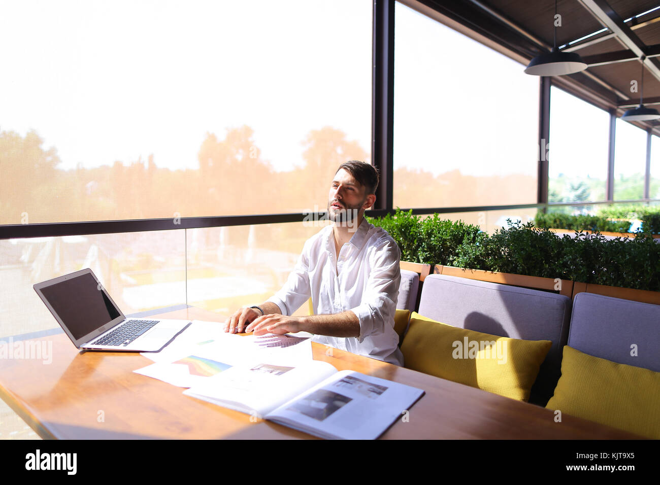 Designer of engineering systems working with laptop and document Stock ...