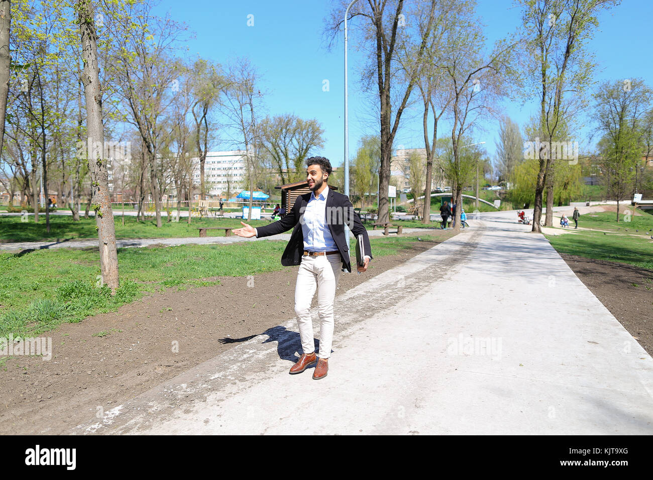 Arabian walking in park and smiling in slow motion Stock Photo - Alamy