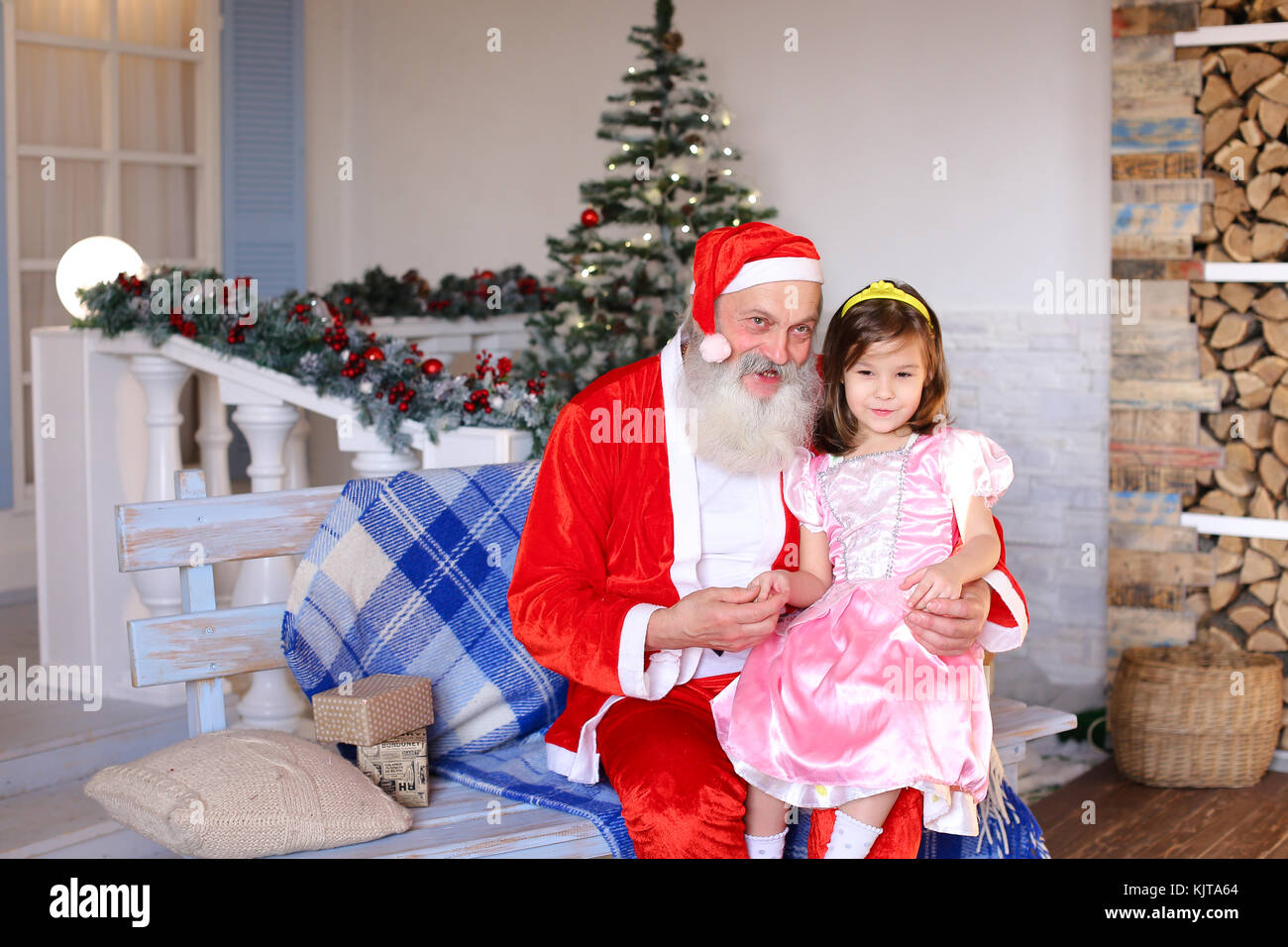 Joyous Santa Claus speaking with little princess Stock Photo - Alamy