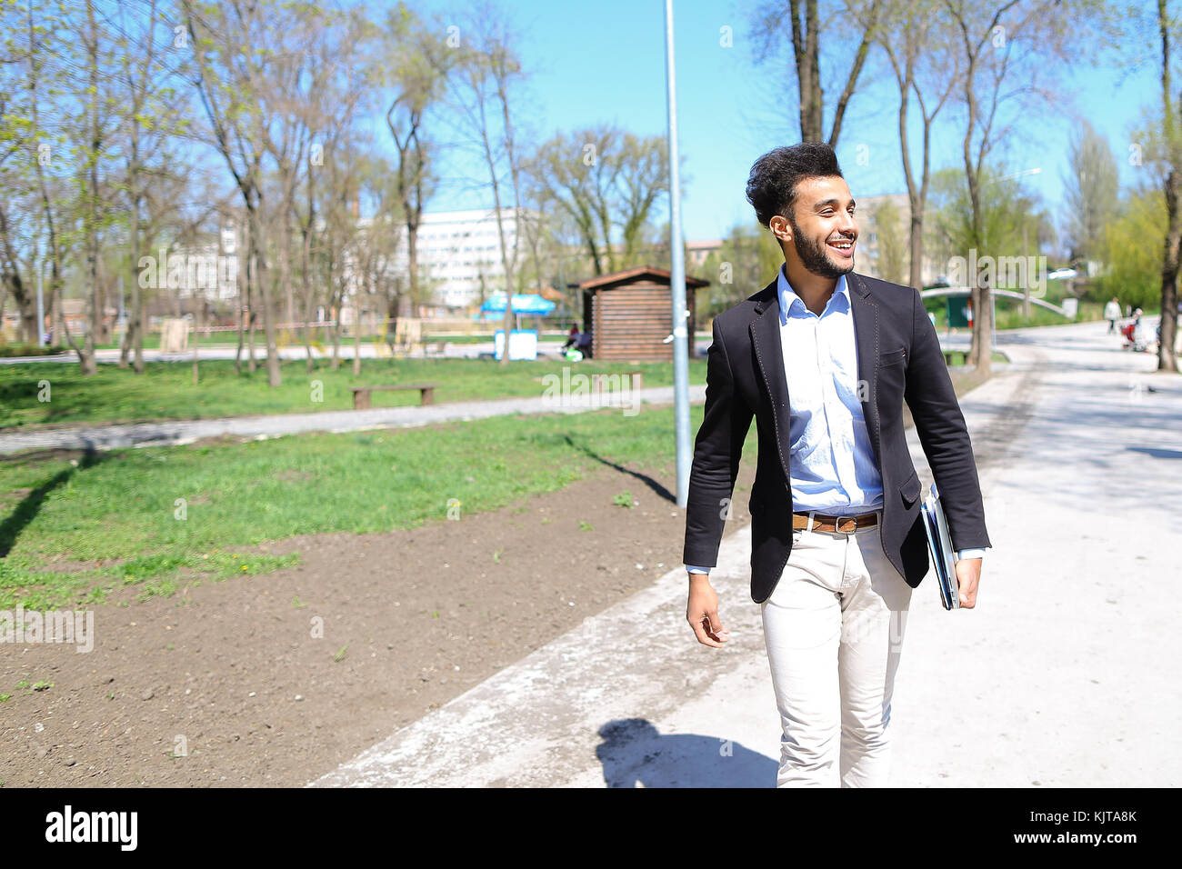 Arabian walking in park and smiling in slow motion Stock Photo - Alamy
