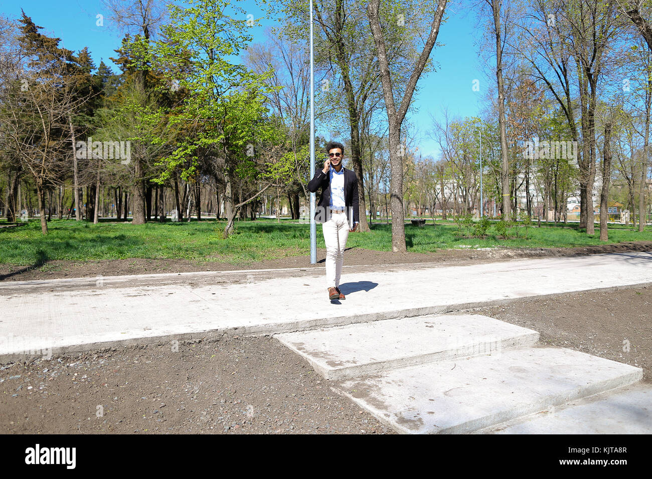 Arabian walking in park and smiling in slow motion Stock Photo - Alamy