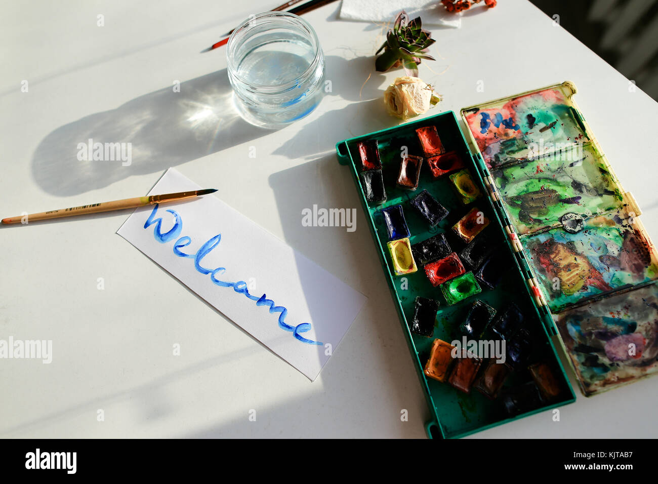 Calligraphic text Welcome, written in colors on white paper, whi Stock ...