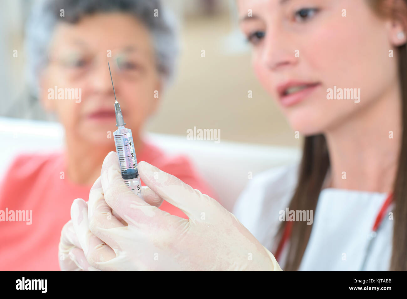 Preparing to give old lady an injection Stock Photo - Alamy