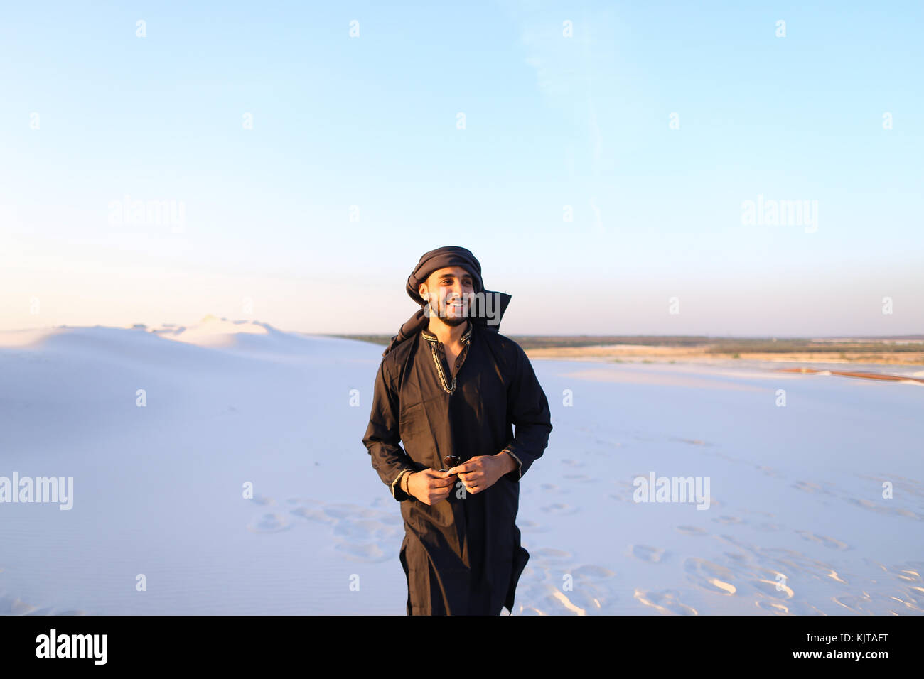 Happy fellow Arabian, walks through desert, smiles and enjoys li Stock ...