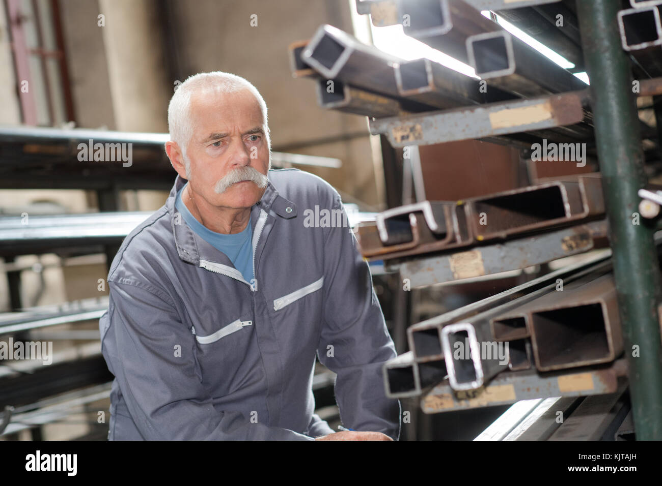 Senior man in metalworking factory Stock Photo - Alamy