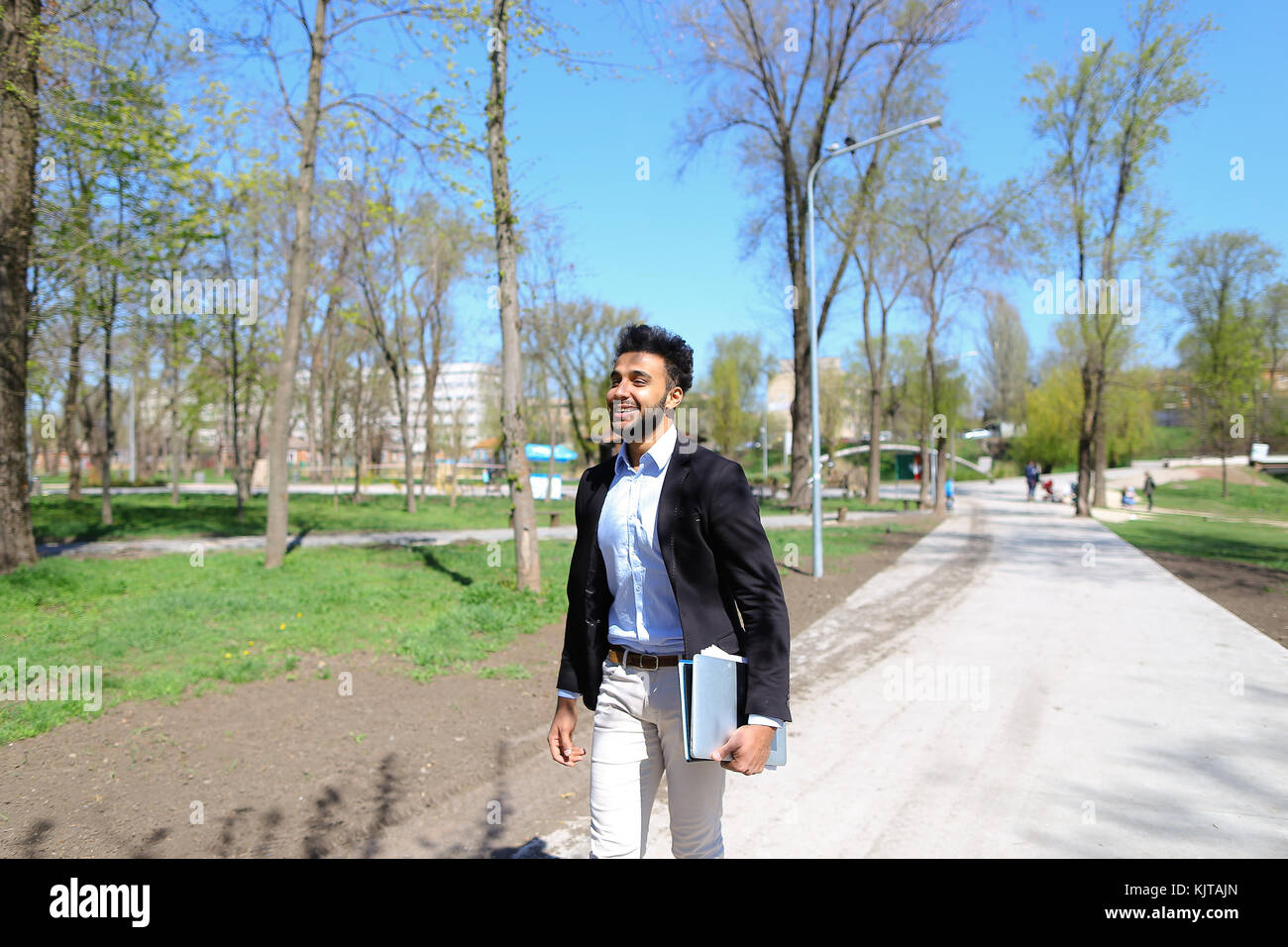 Arabian walking in park and smiling in slow motion Stock Photo - Alamy