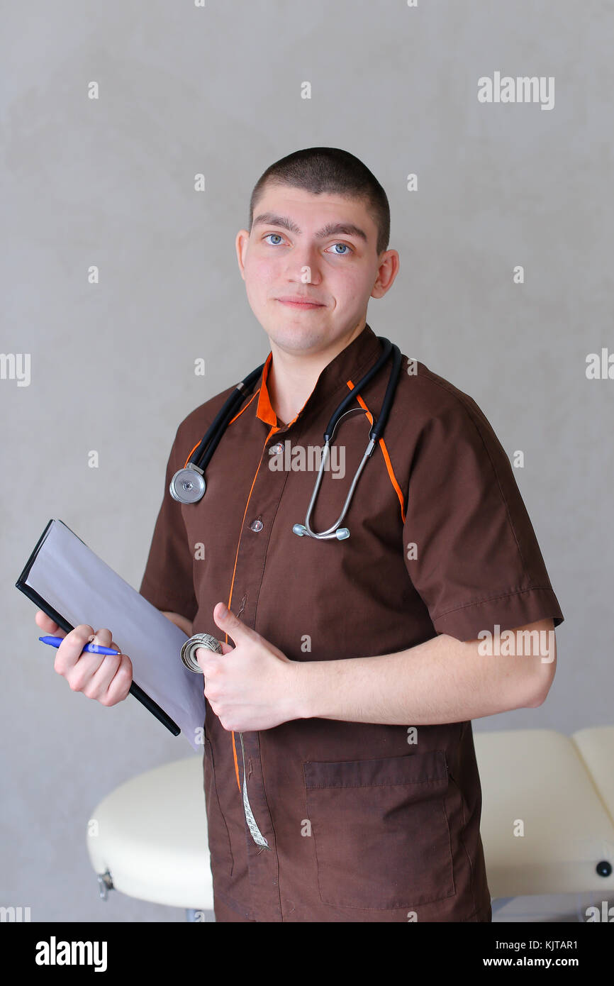 Professional male therapist looks at camera with smile and stand Stock ...
