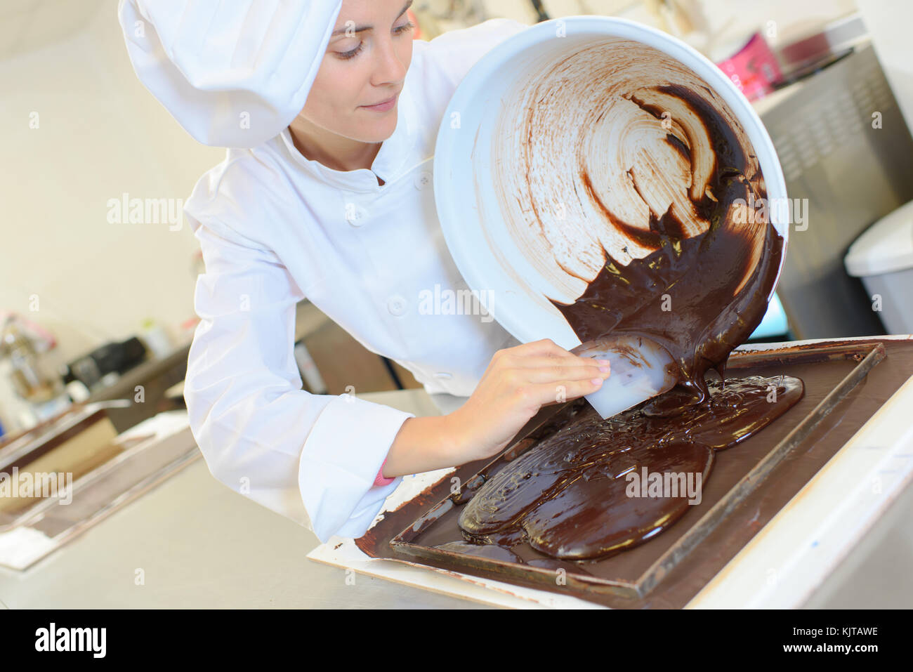 pouring chocolate to bake Stock Photo - Alamy