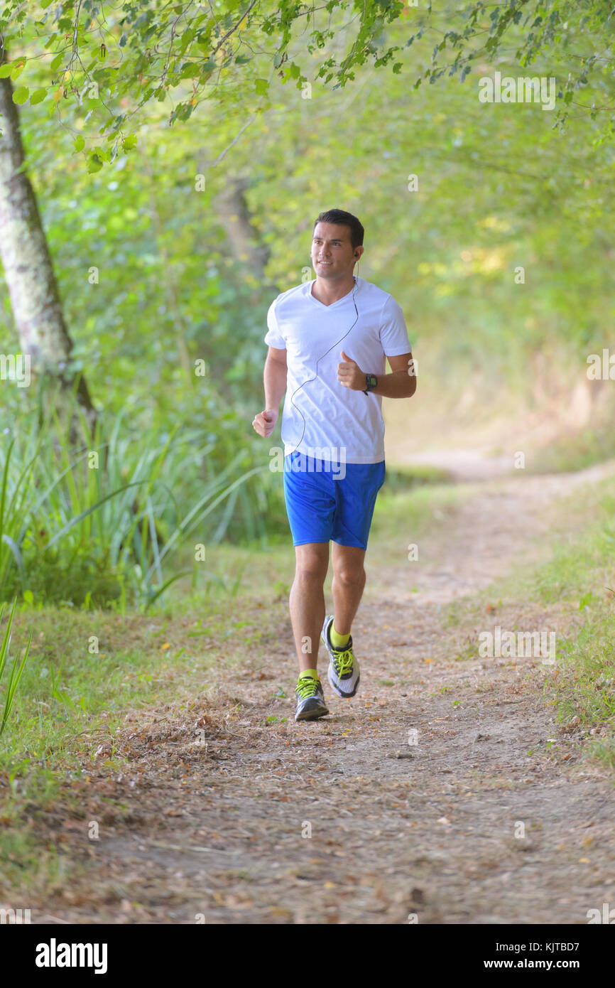 young man running in the forest Stock Photo - Alamy