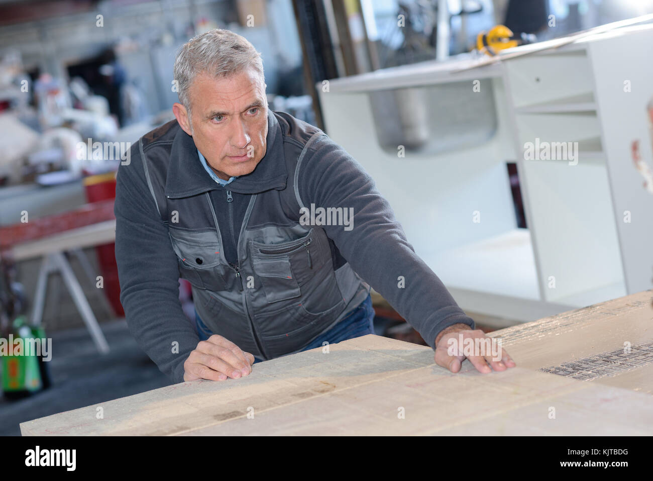 Senior man working in factory Stock Photo - Alamy