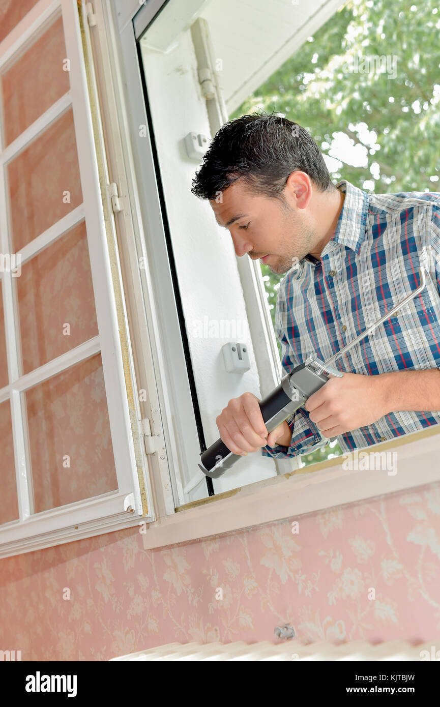 man fixing window Stock Photo - Alamy