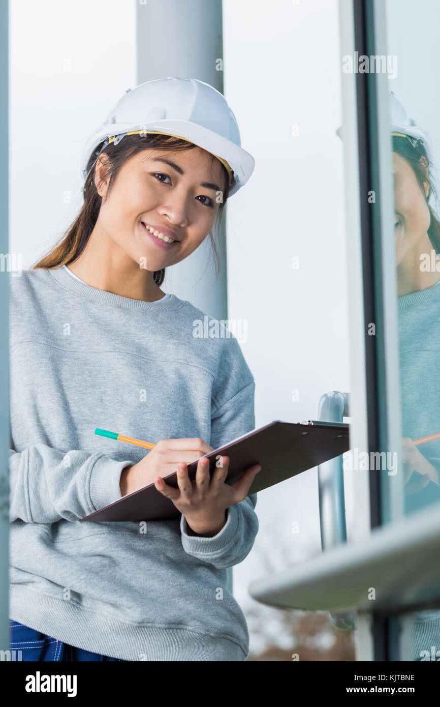 Portrait of asian lady holding clipboard Stock Photo - Alamy