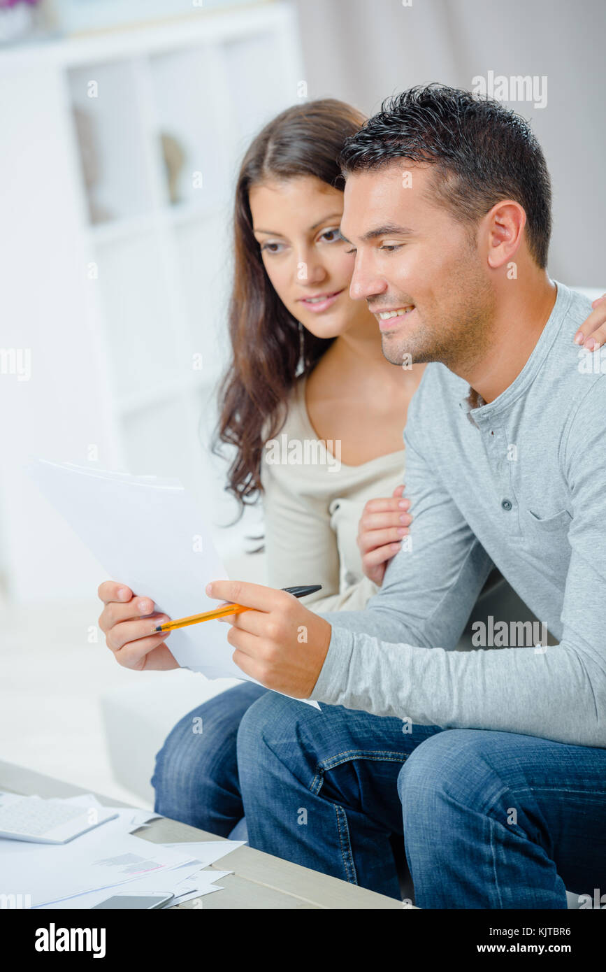 Excited couple reading letter Stock Photo - Alamy