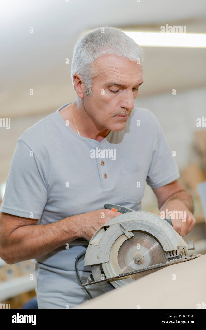 Woodworker using a circular saw Stock Photo - Alamy