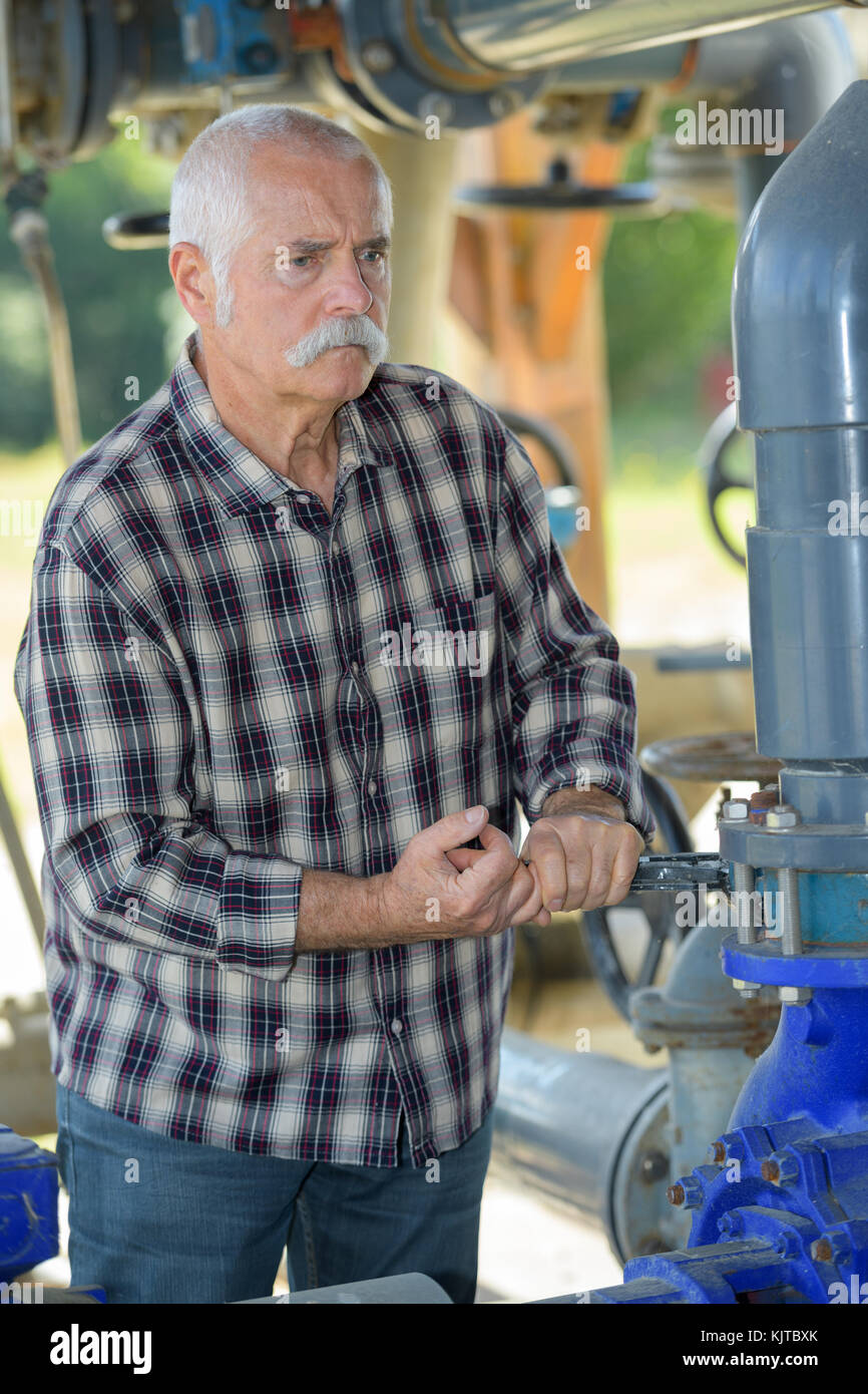 man inspecting the pipes Stock Photo - Alamy