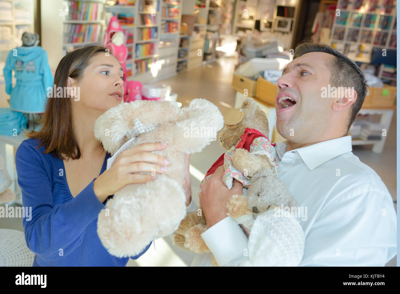 Couple hugging soft toys in store Stock Photo - Alamy