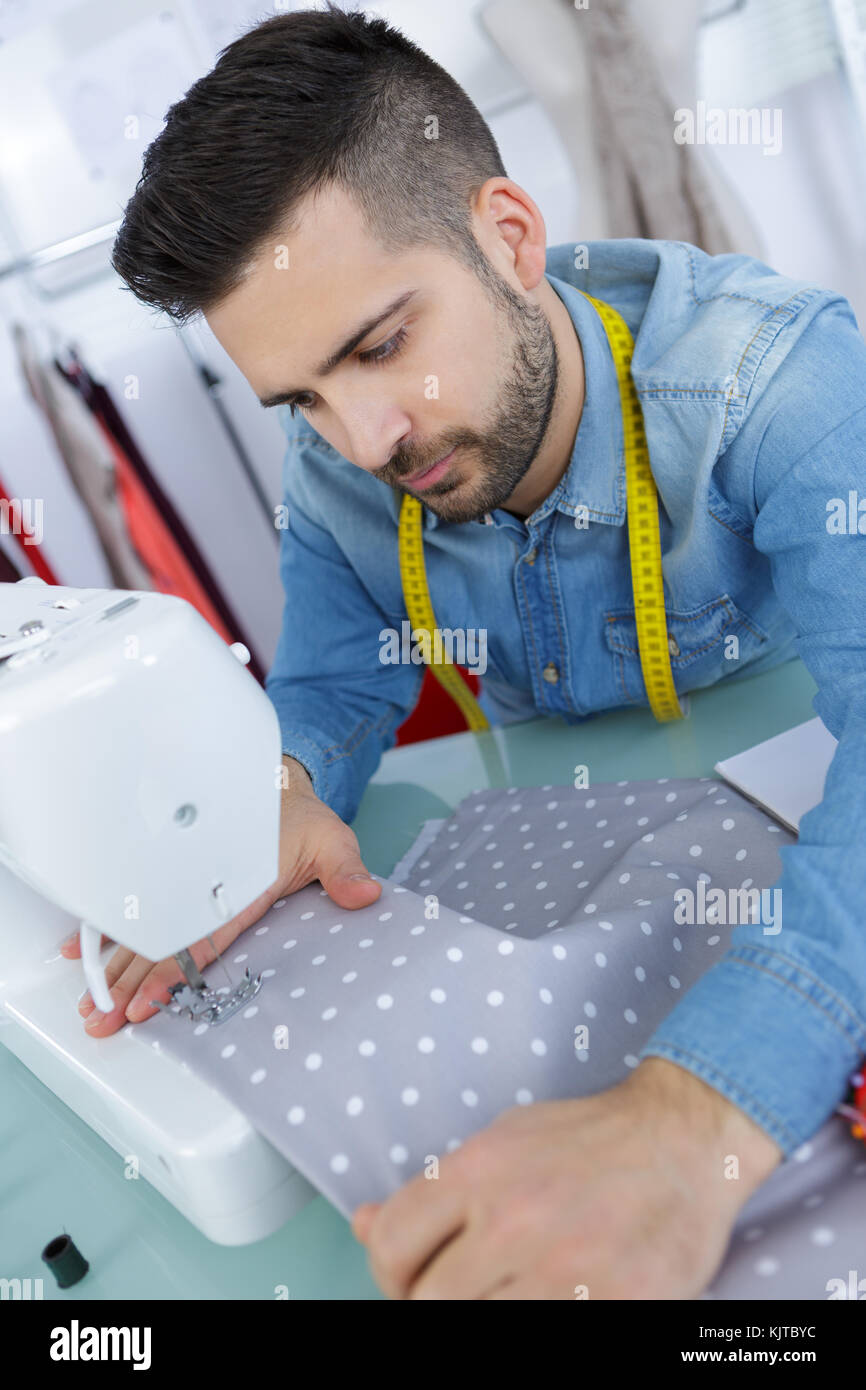 oung man sewing a dress in his studio Stock Photo - Alamy