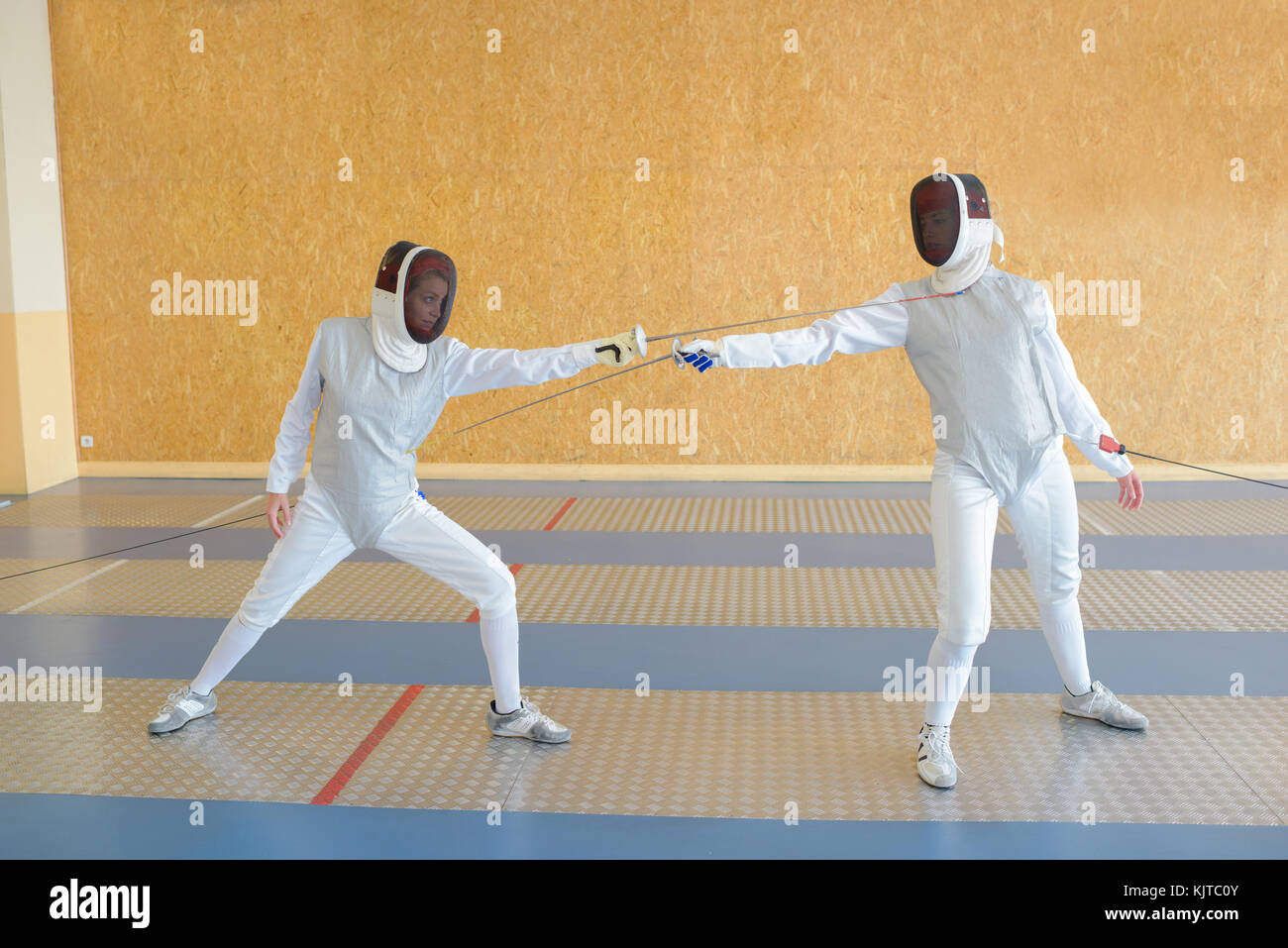 Two people in fencing combat Stock Photo - Alamy