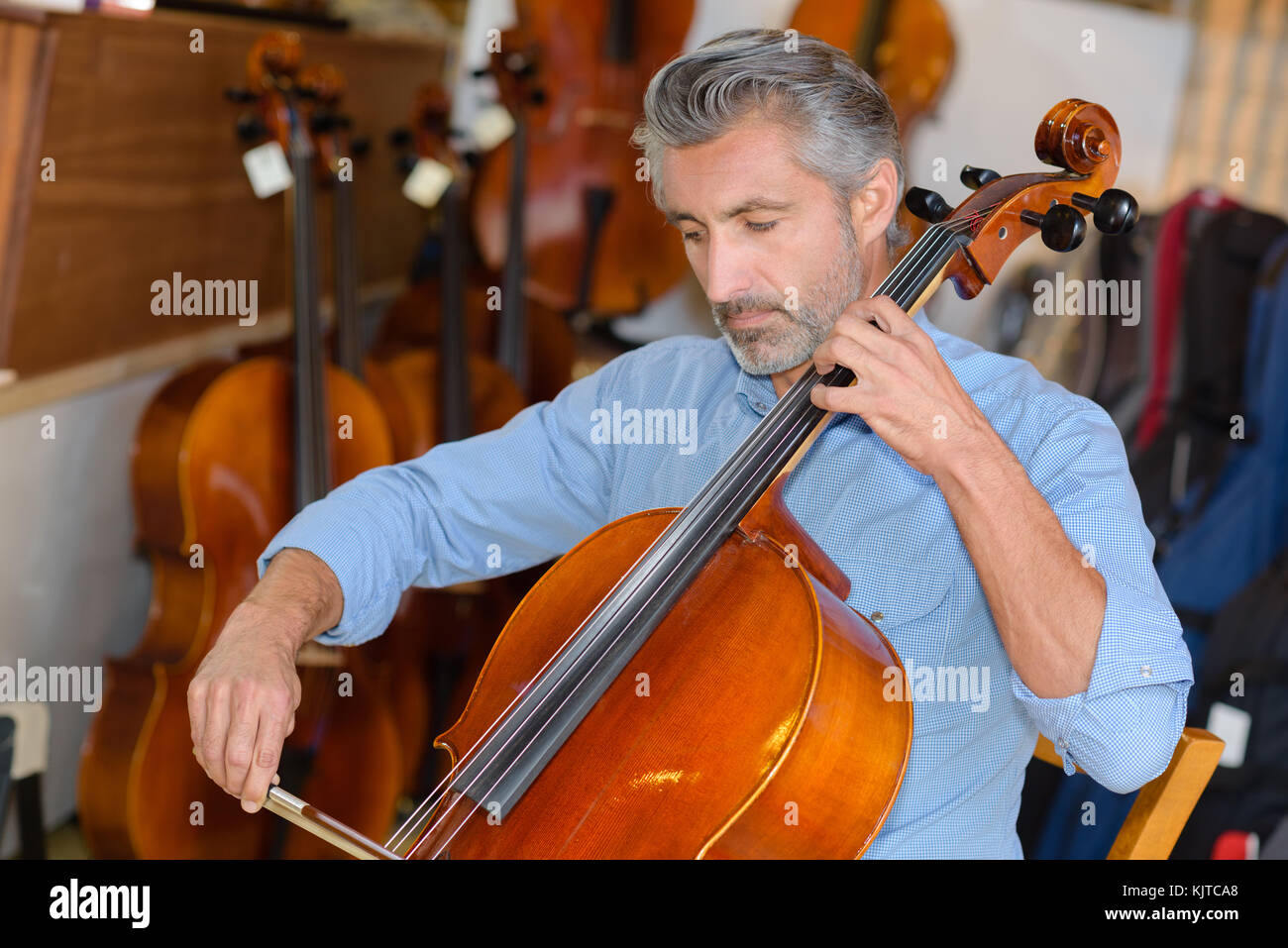 luthier tuning a cello Stock Photo - Alamy