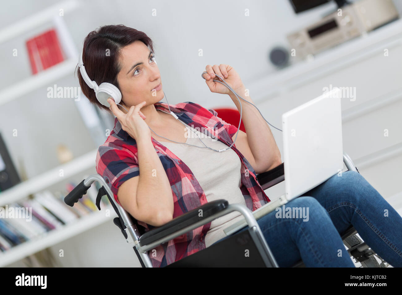 disabled woman in wheelchair using internet at home Stock Photo - Alamy
