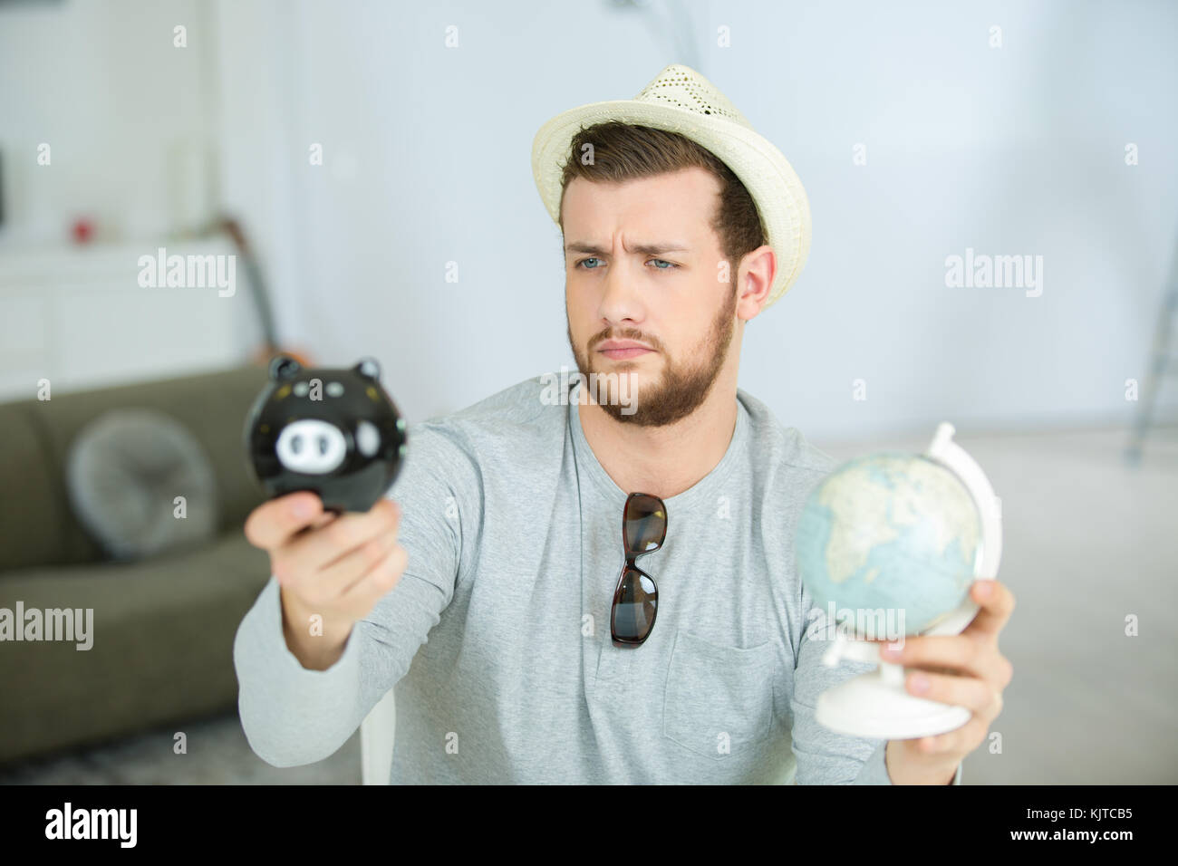 man with a piggy bank and a gobe Stock Photo - Alamy