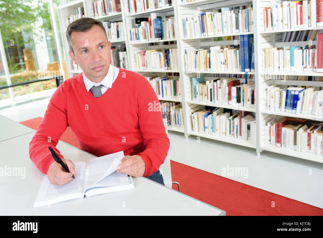 Studying alone in library hi-res stock photography and images - Alamy