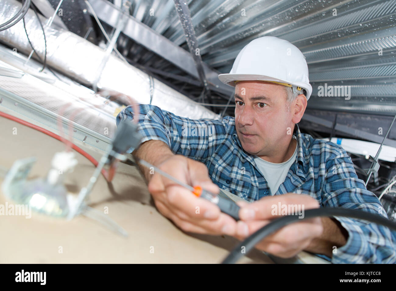 Electrician installs light on ceiling hi-res stock photography and ...