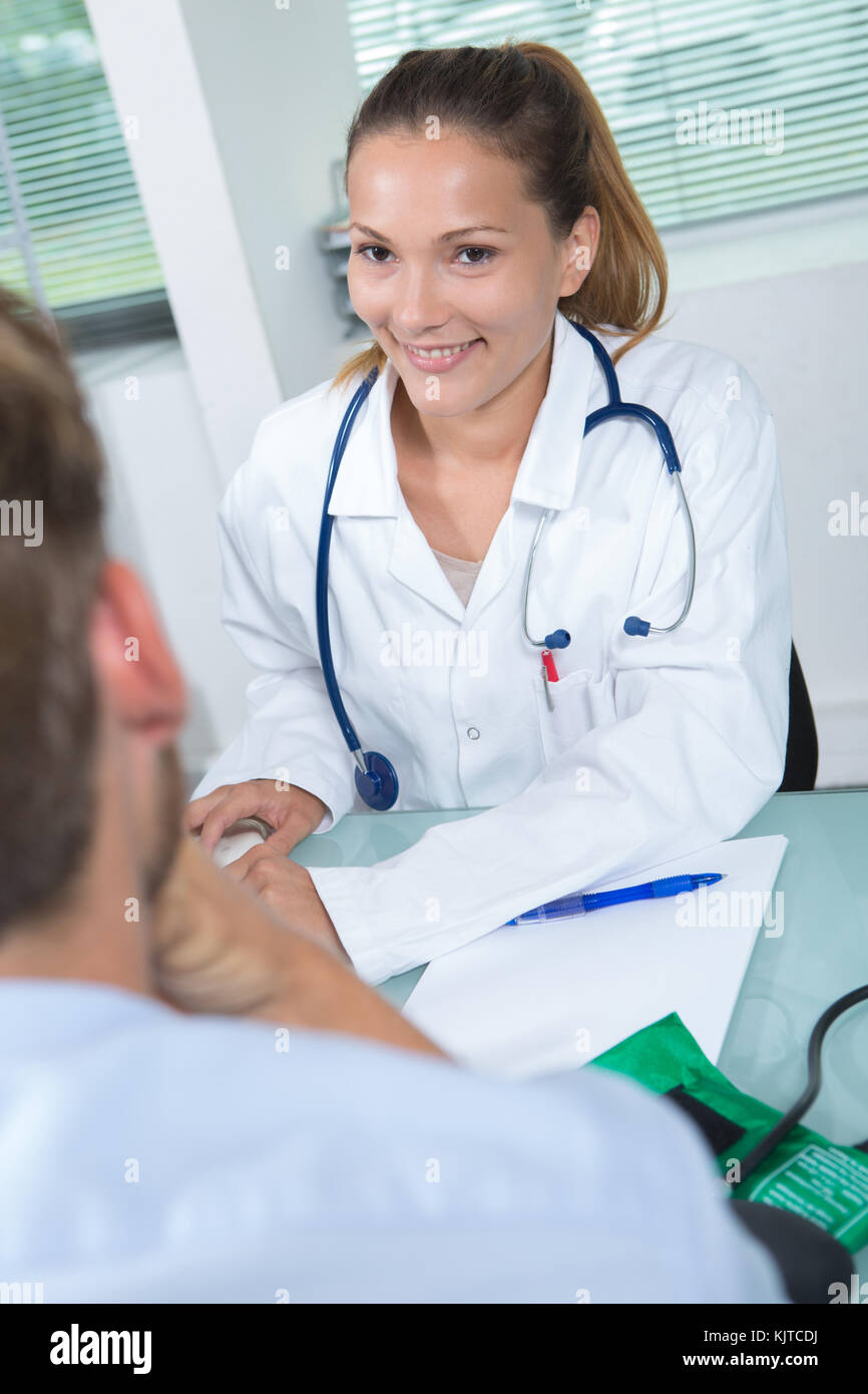female doctor looking at patient in clinic Stock Photo - Alamy