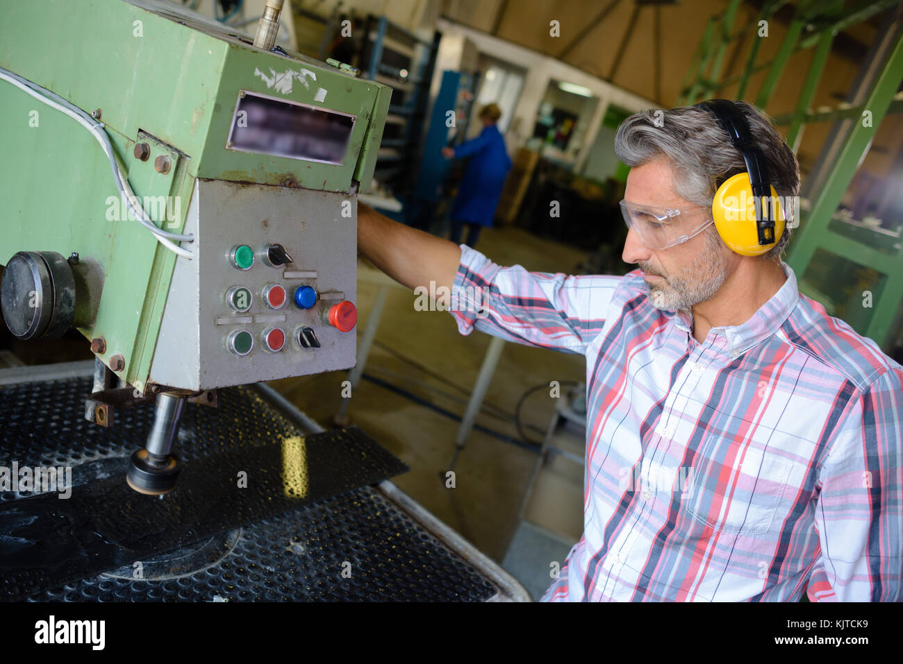 worker operating machine in factory Stock Photo - Alamy
