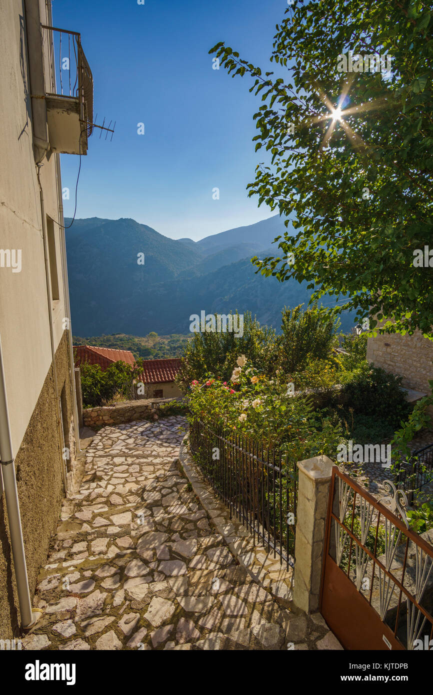 Architectural old buildings and narrow paved streets in a typical Greek ...