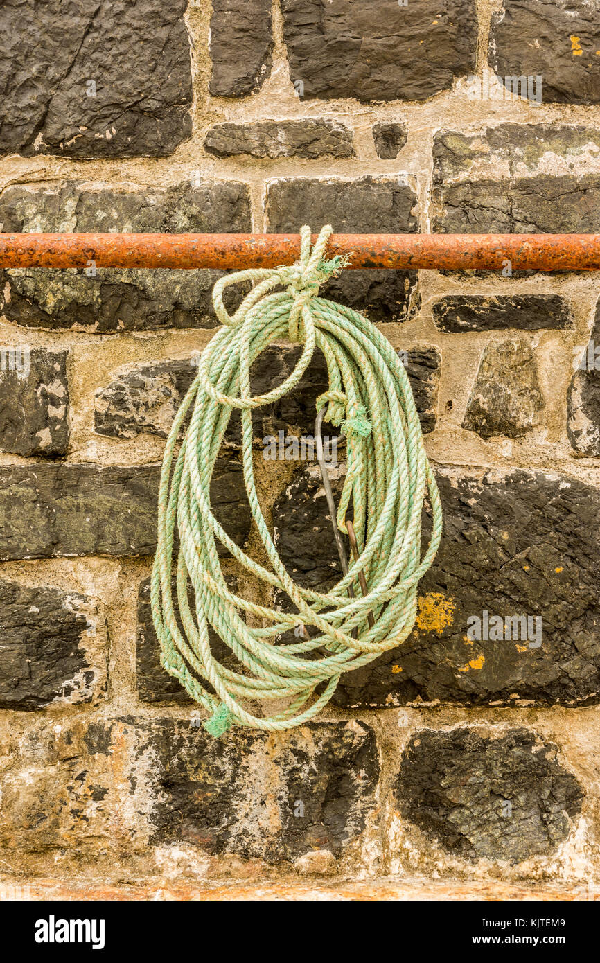 Rope hanging from a rusty rail Stock Photo - Alamy