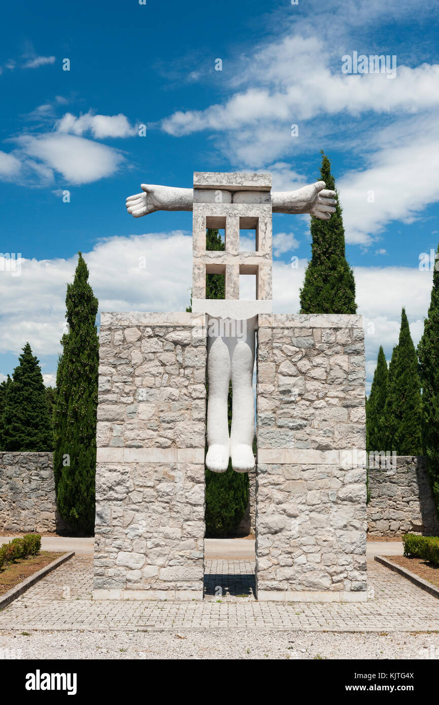 strange crucifix sculpture in Labin cemetary, Croatia Stock Photo - Alamy