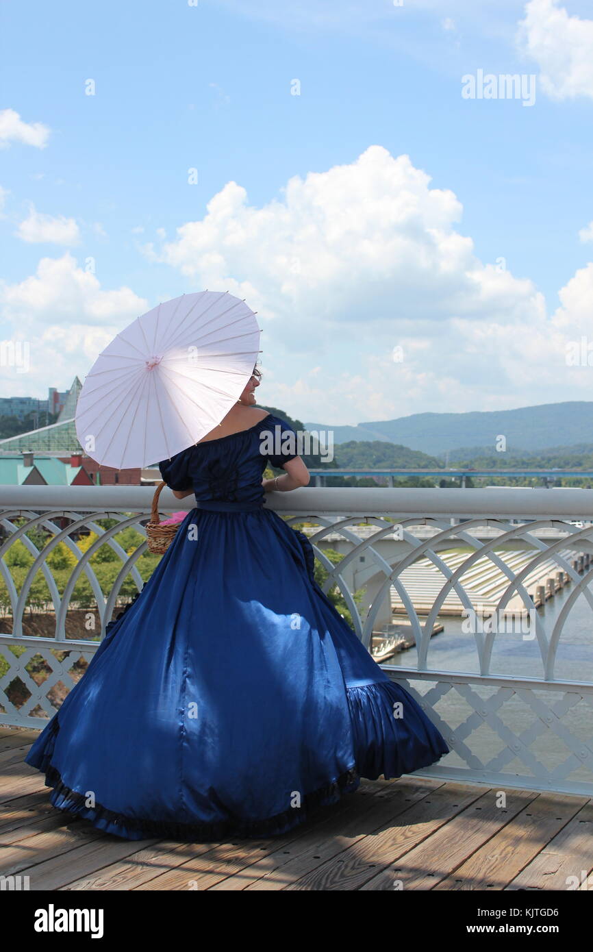 Woman on bridge overlooking a river Stock Photo - Alamy