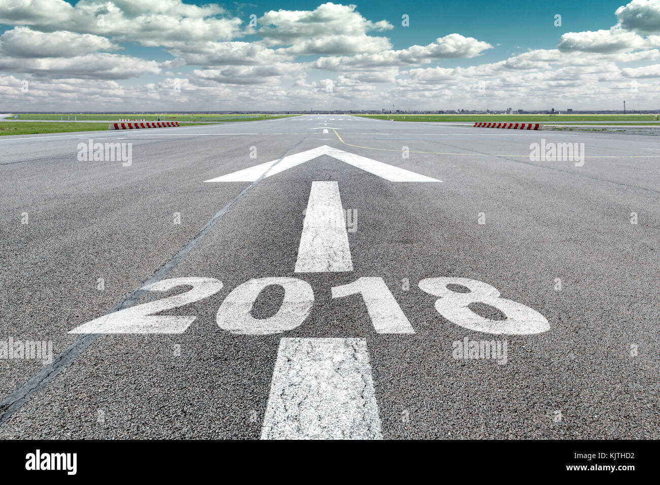 Runway of airport with arrow guideline and year 2018 letters painted on ...