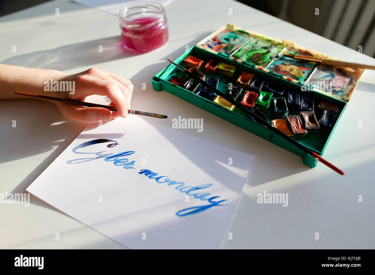 Female calligrapher creates inscription for sale, using brushes Stock ...
