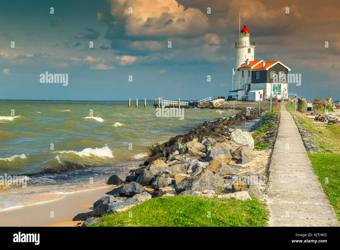 Wonderful lighthouse on the island of Marken and stunning beach with ...