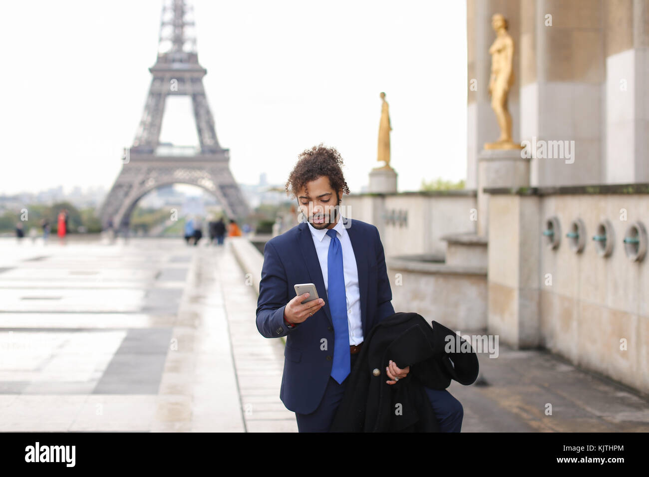 Hispanic journalist close to Eiffel Tower reading newspaper and Stock ...