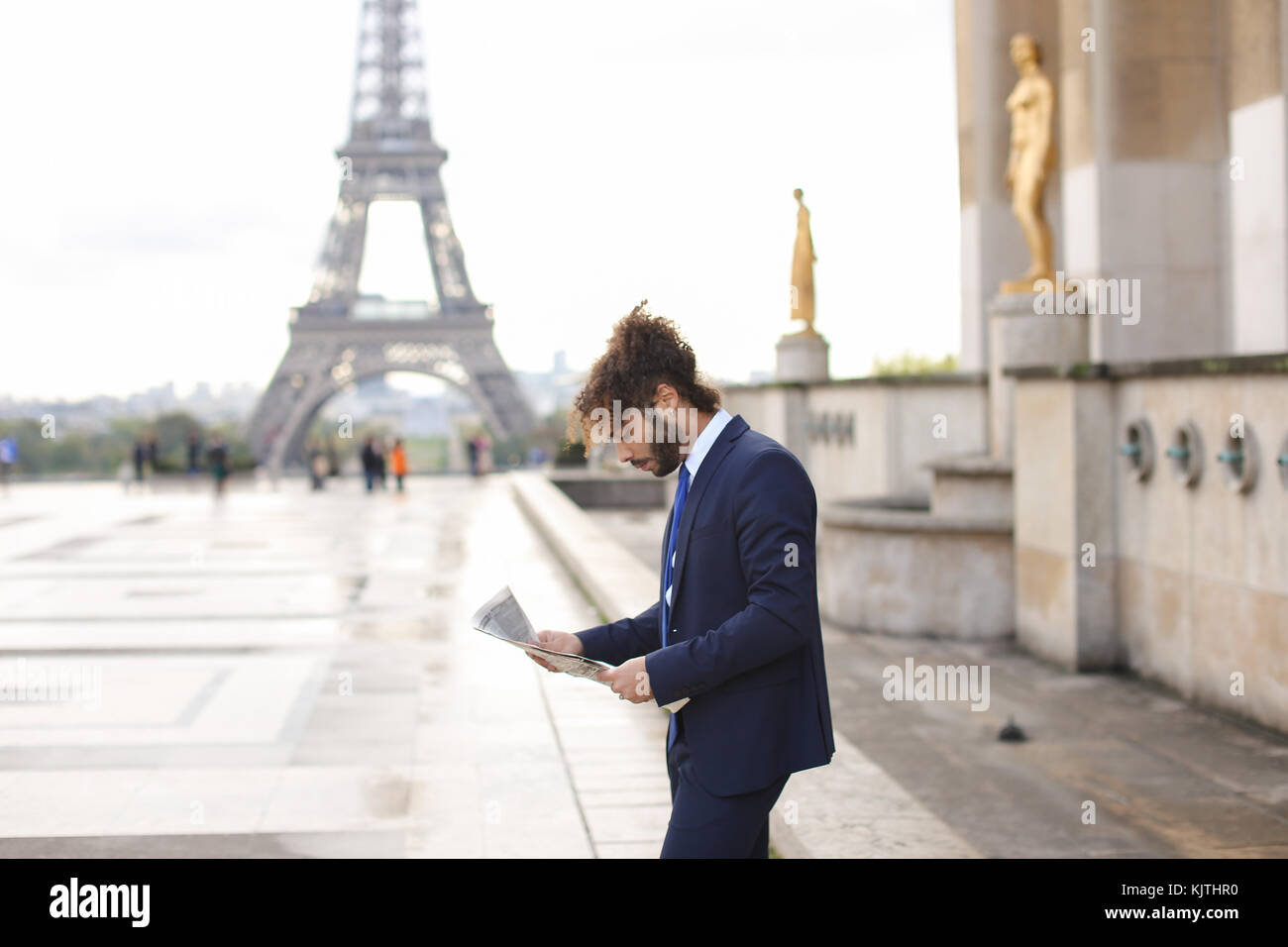 Hispanic journalist close to Eiffel Tower reading newspaper and Stock ...