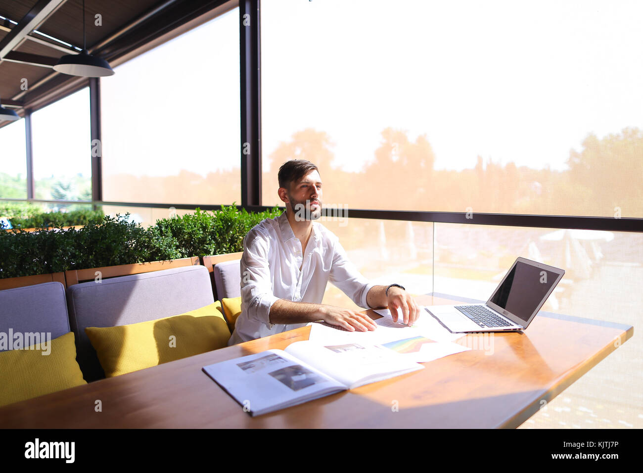 Designer of engineering systems working with laptop and document Stock ...