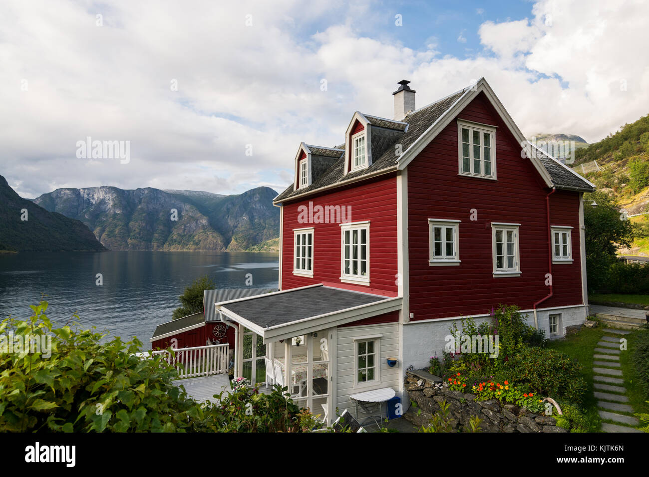 AURLAND, NORWAY - AUGUST 2017: red wooden house standing on the fjord ...