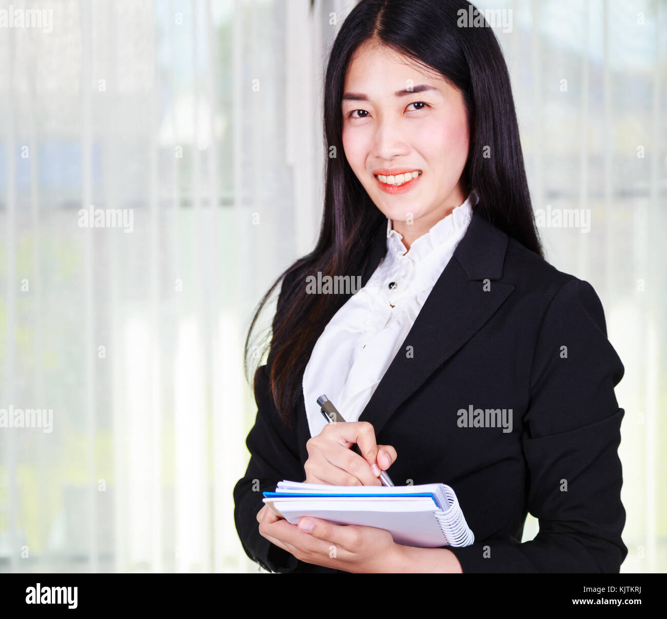 young business women standing and writing down on notebook Stock Photo ...