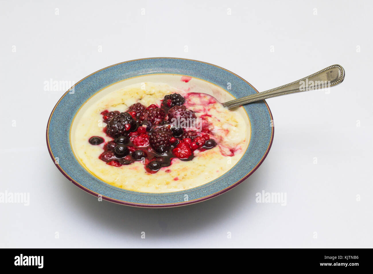 A delicious bowl of hot porridge with a forest fruit selection and ...