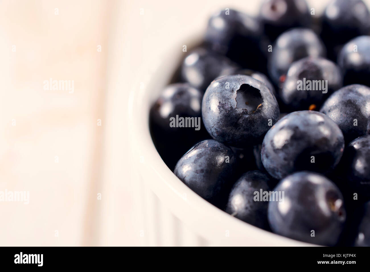 Macro shoot of blueberry in the cup.Selective focus on the left ...
