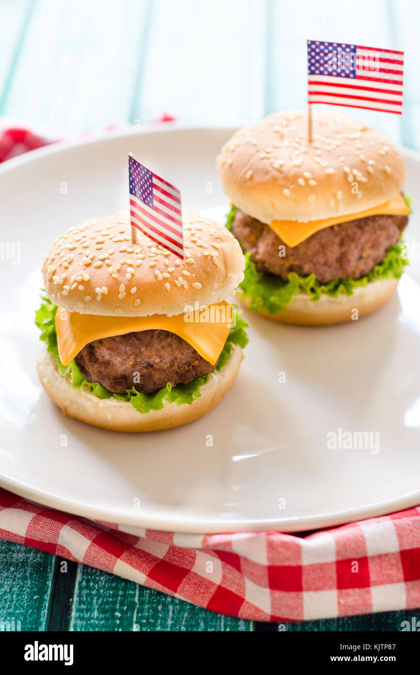 Mini beef burgers with American flag in white plate,selective focus ...